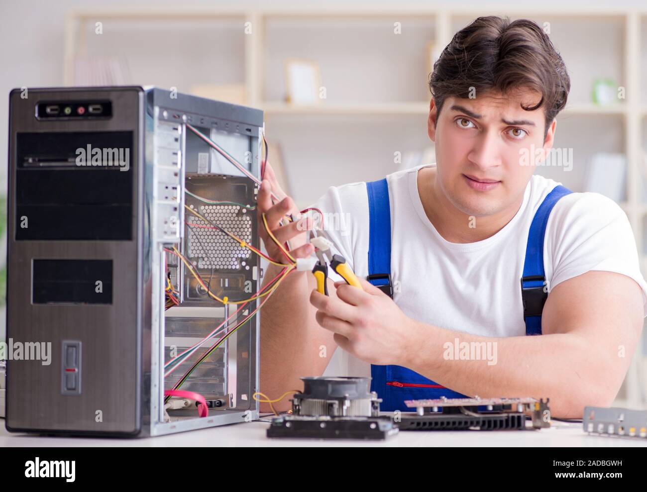 Computer repairman repairing desktop computer Stock Photo - Alamy