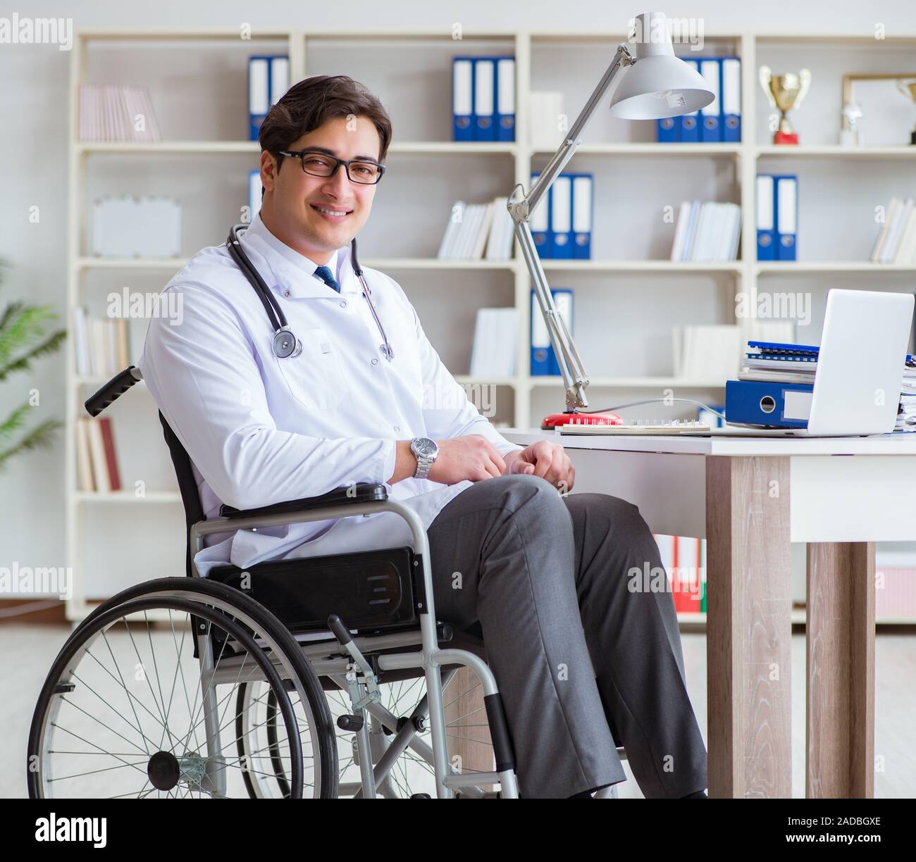 Disabled doctor on wheelchair working in hospital Stock Photo - Alamy
