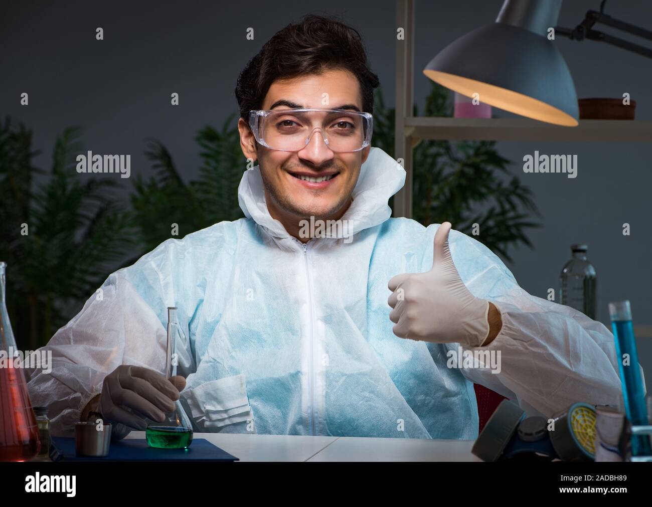 The young male lab chemist late at night in overtime time Stock Photo ...