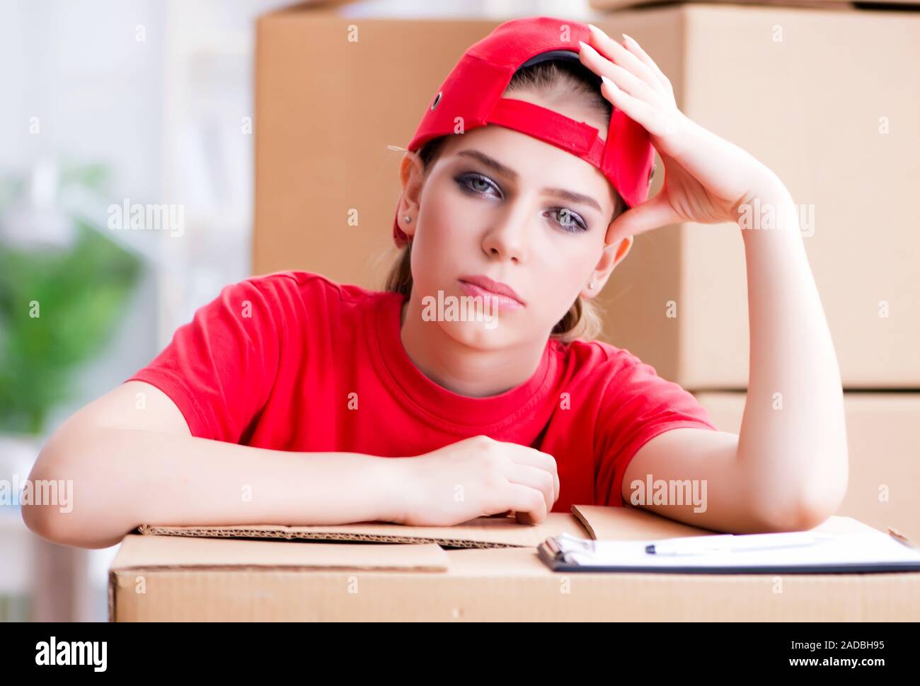 Sad woman packing boxes hi-res stock photography and images - Alamy