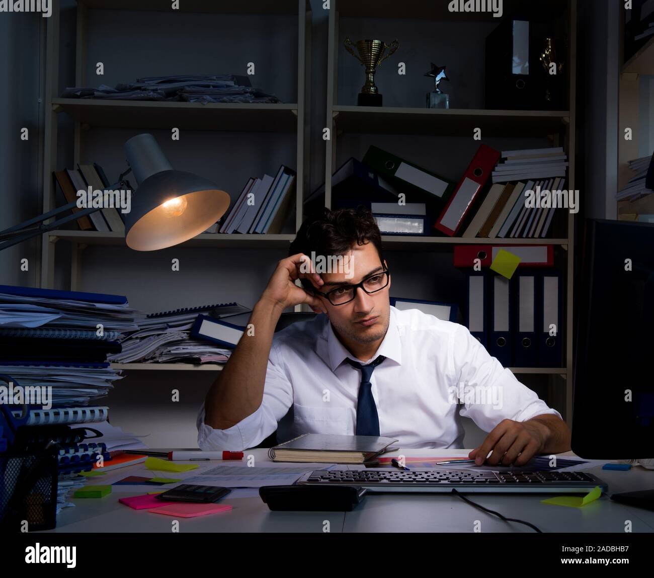 Man Businessman working late hours in the office Stock Photo - Alamy