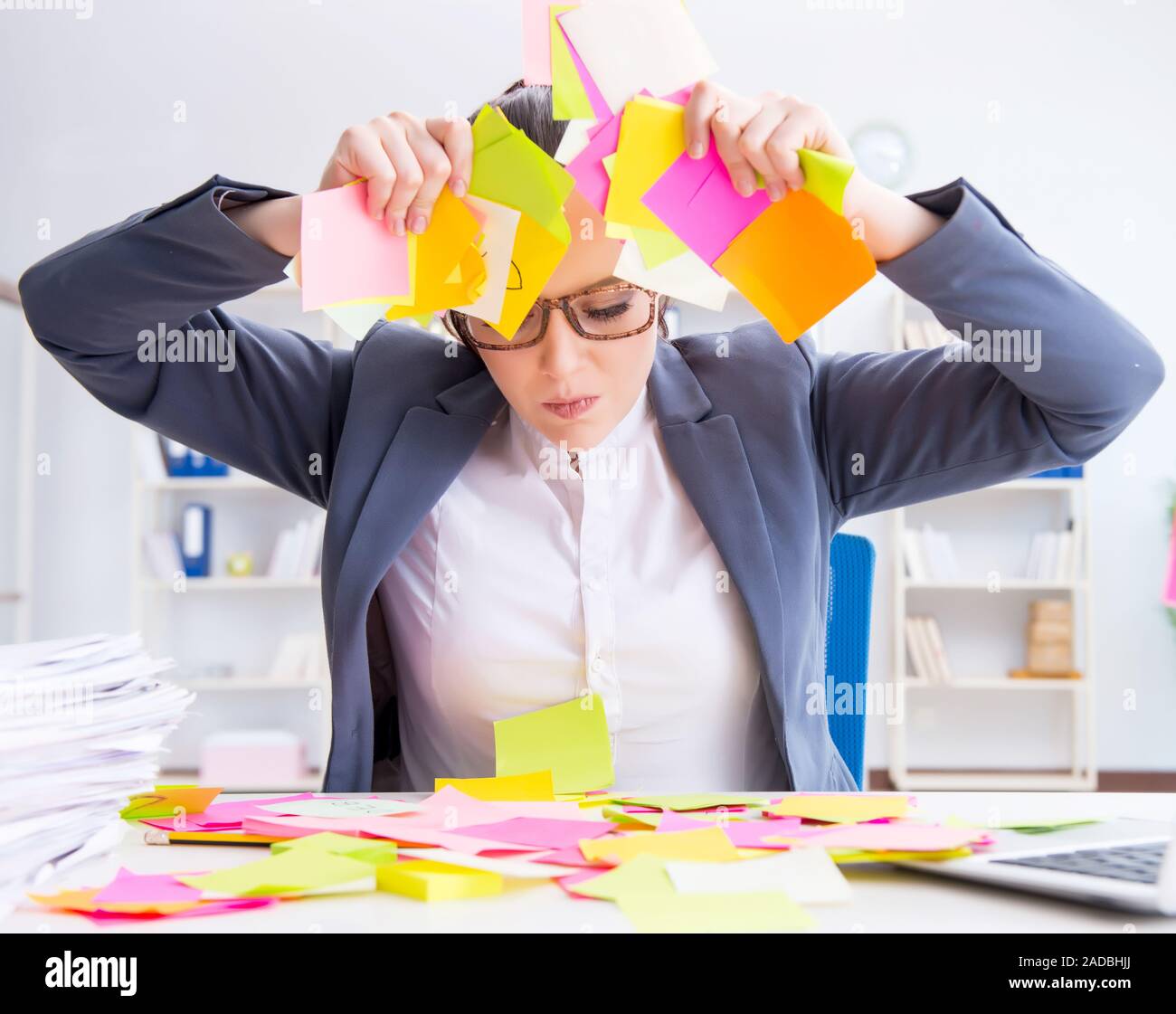 Businesswoman with conflicting priorities in office Stock Photo - Alamy