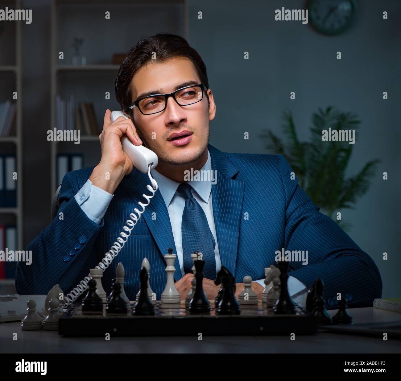 Businessman playing chess in strategy concept Stock Photo - Alamy