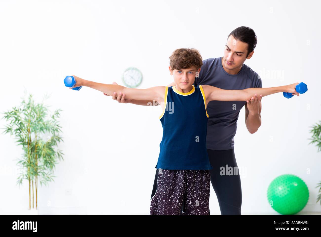 Young father and his son doing exercises Stock Photo - Alamy