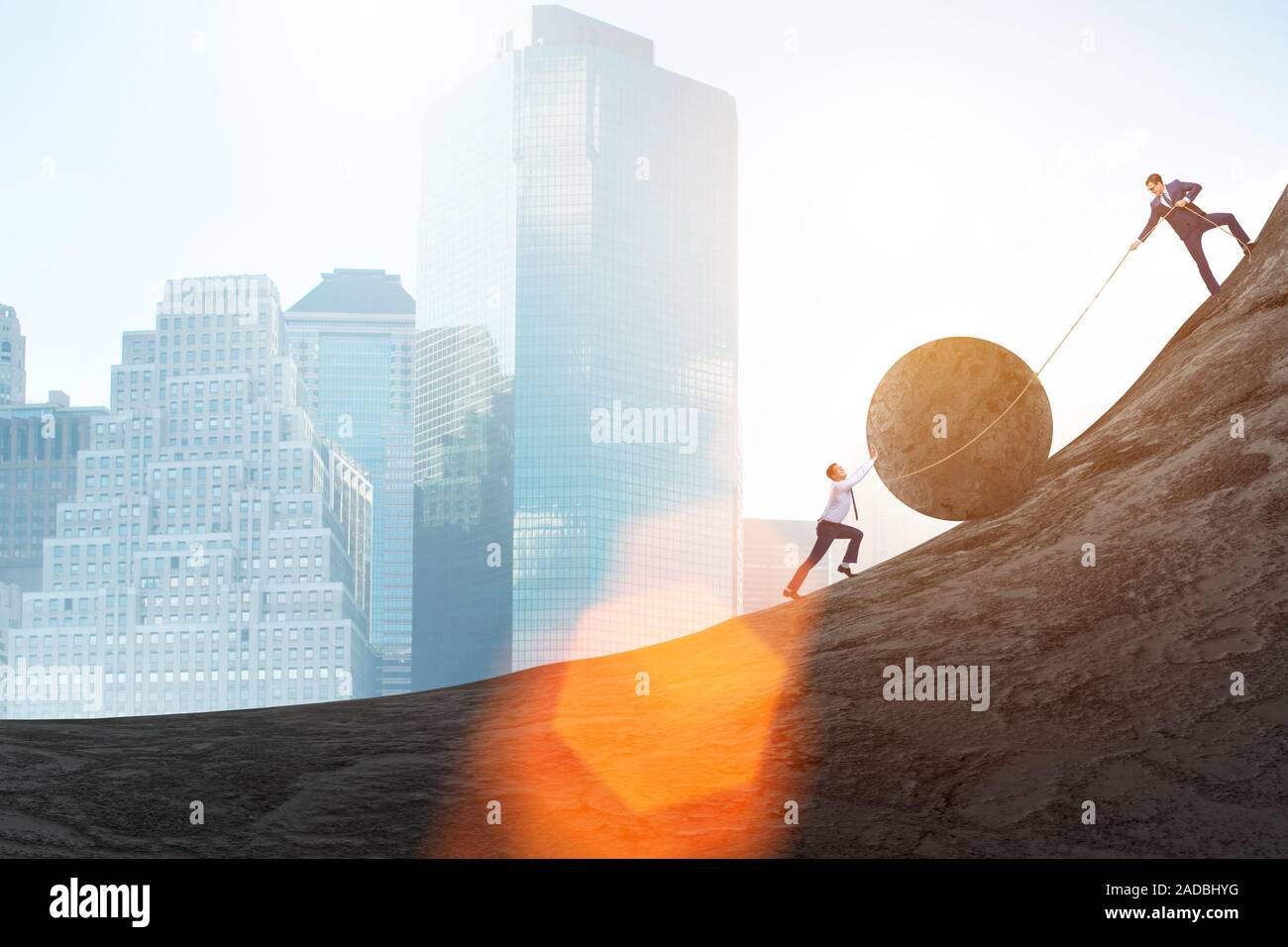 Teamwork example with Business people pushing stone to top Stock Photo ...