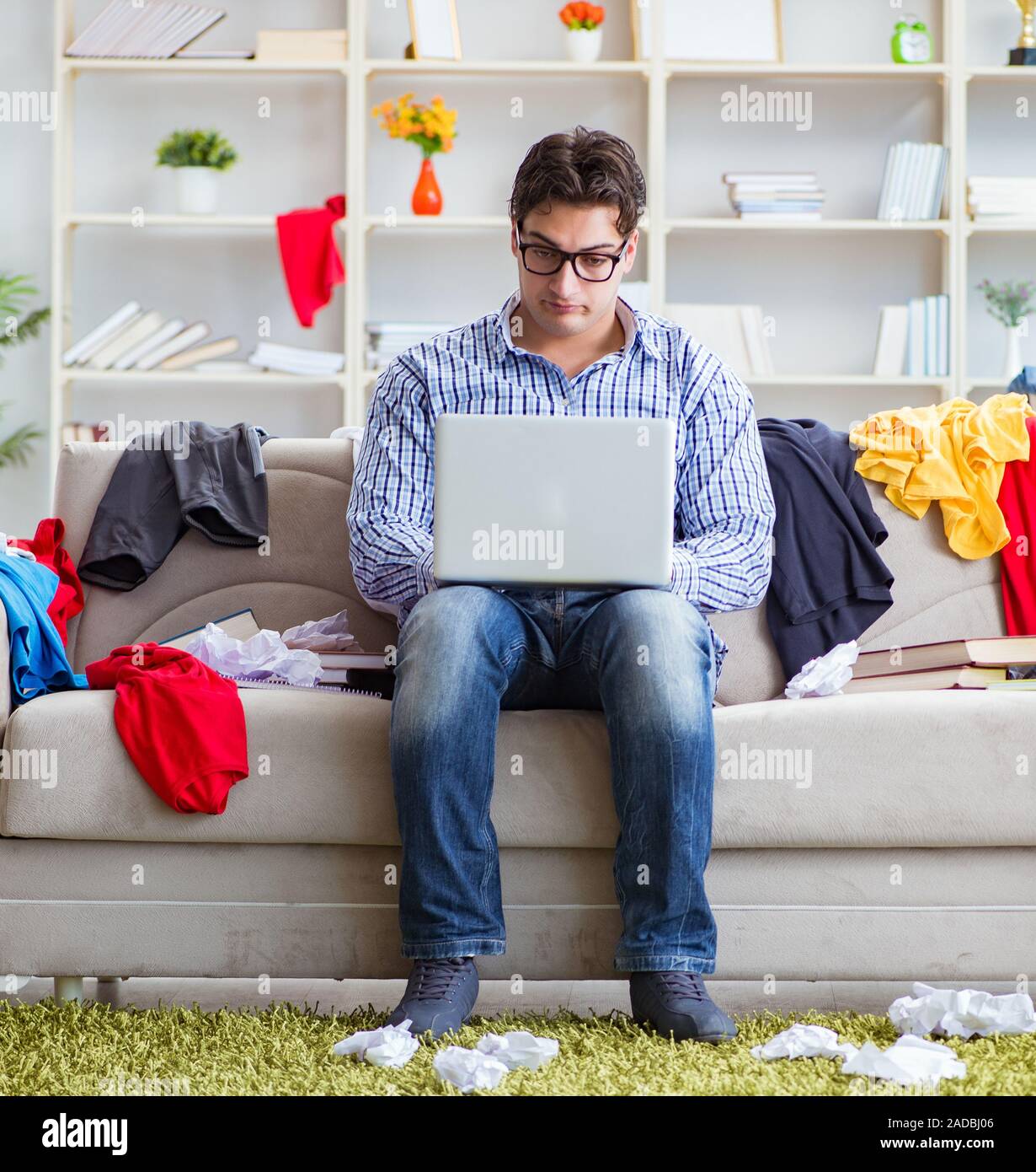 Young man working studying in messy room Stock Photo - Alamy