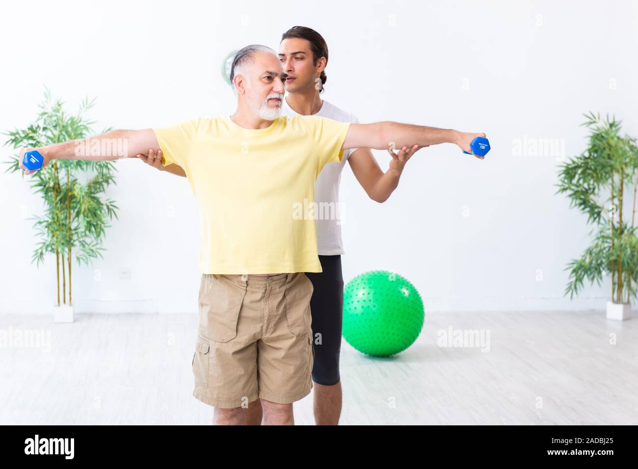 Senior man is doing rehab exercises at home hi-res stock photography ...