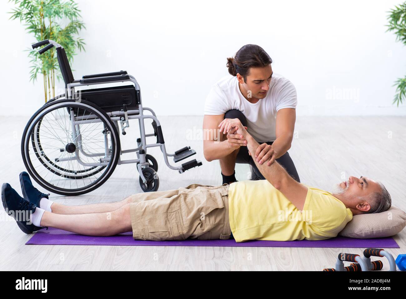 Old injured man doing exercises indoors Stock Photo - Alamy