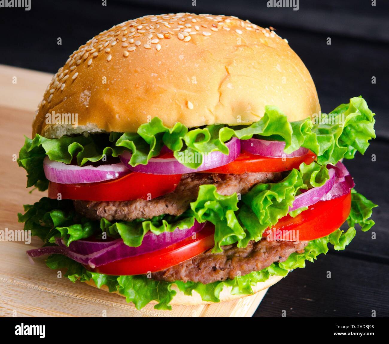 Burger served in bun in nutrition fast food concept Stock Photo - Alamy
