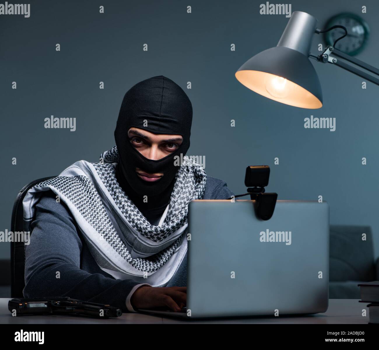Hacker wearing balaclava mask hacking computer Stock Photo - Alamy
