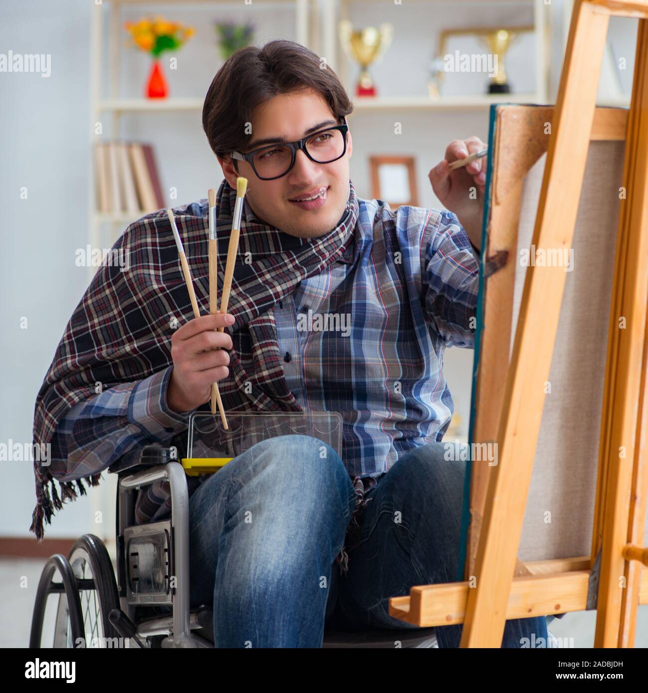 Disabled artist painting picture in studio Stock Photo - Alamy