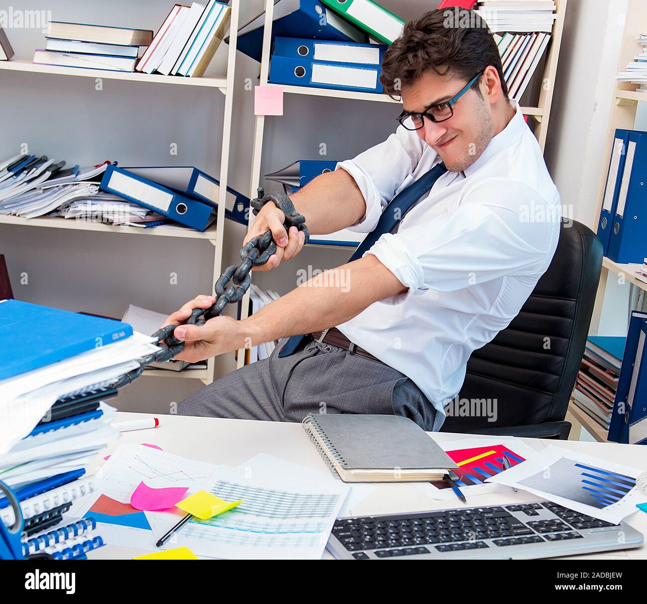 The employee attached and chained to his desk with chain Stock Photo ...