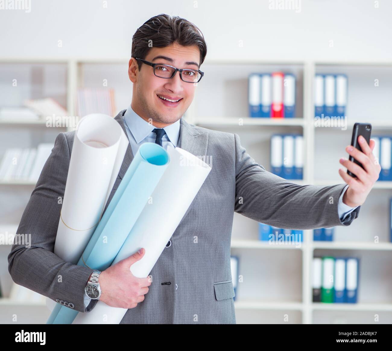 Businessman engineer draftsman with blueprints drawings Stock Photo - Alamy