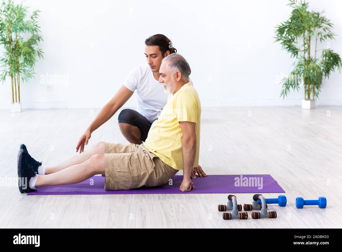 Senior man is doing rehab exercises at home hi-res stock photography ...