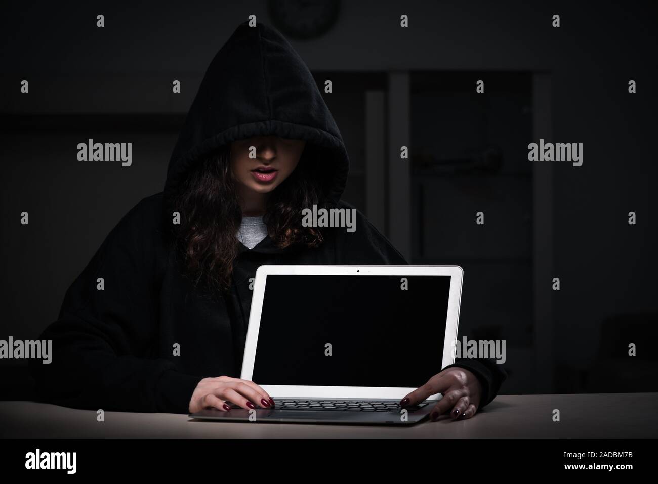 Female hacker hacking security firewall late in office Stock Photo - Alamy