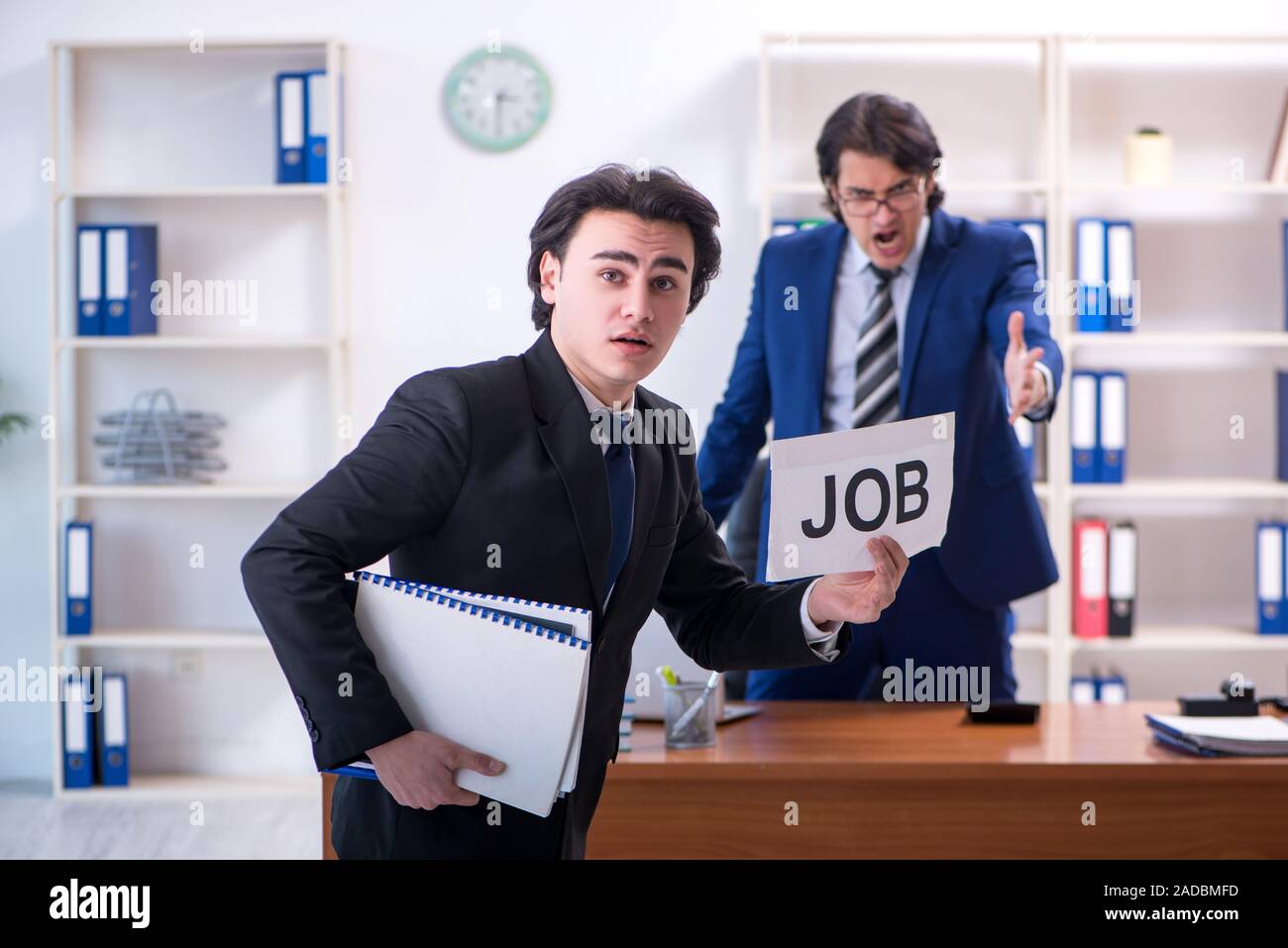 Boss and his male assistant working in the office Stock Photo - Alamy