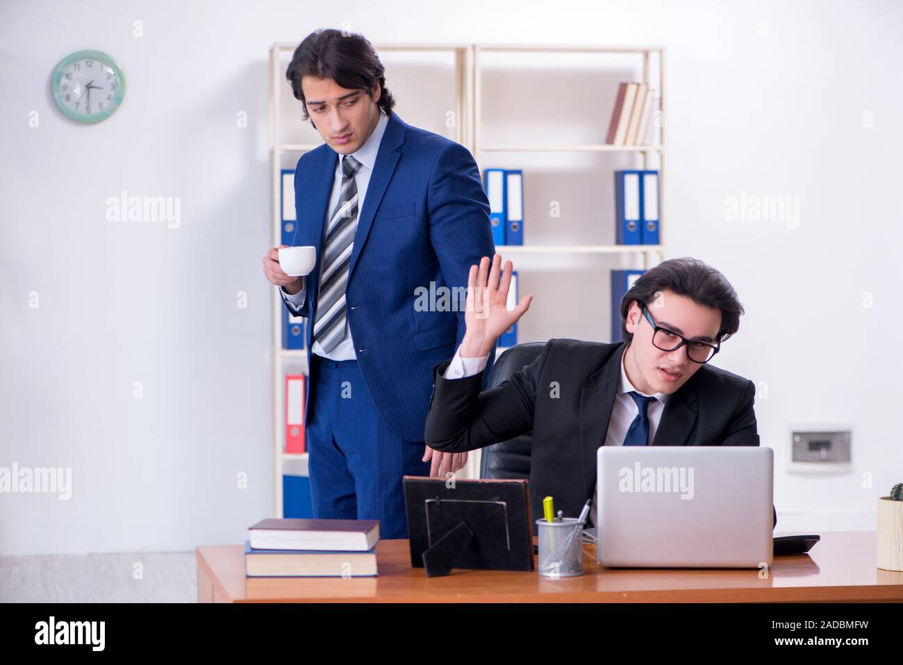 Boss and his male assistant working in the office Stock Photo - Alamy