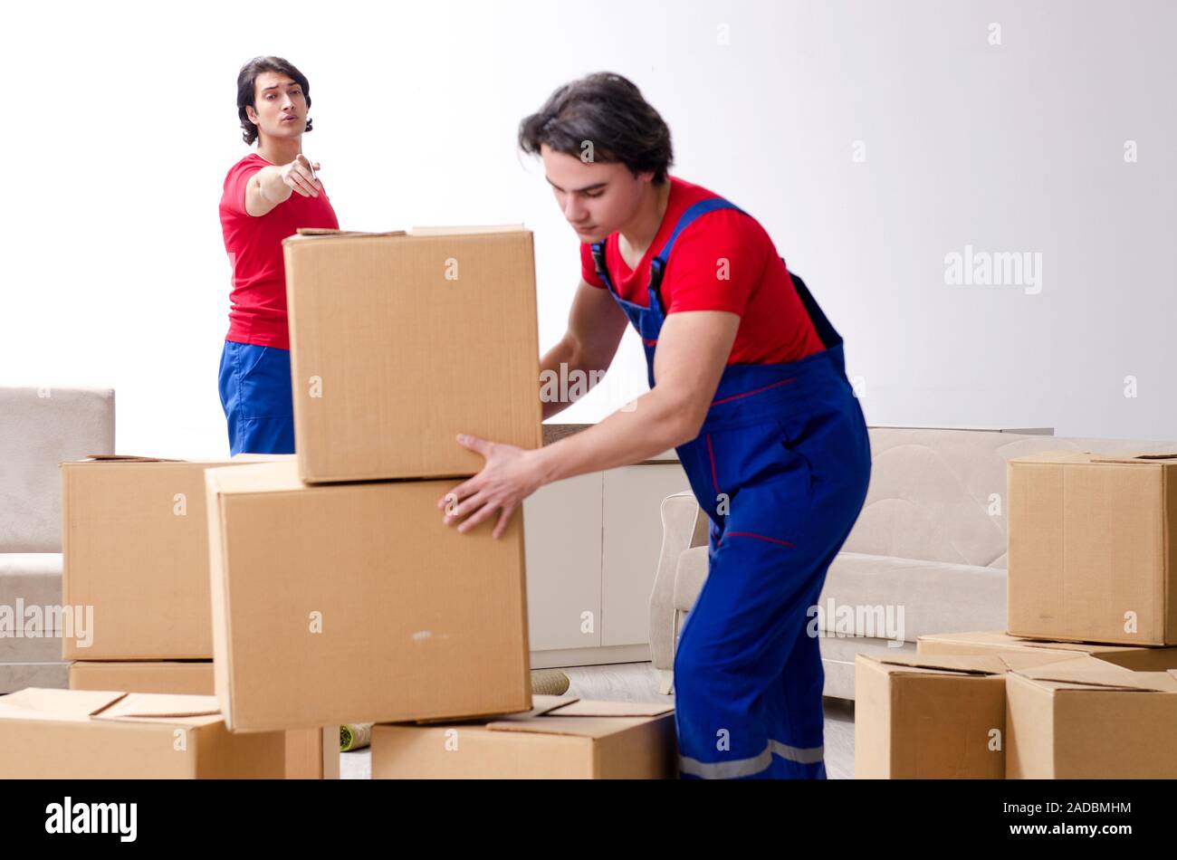 Two young contractor employees moving personal belongings Stock Photo ...