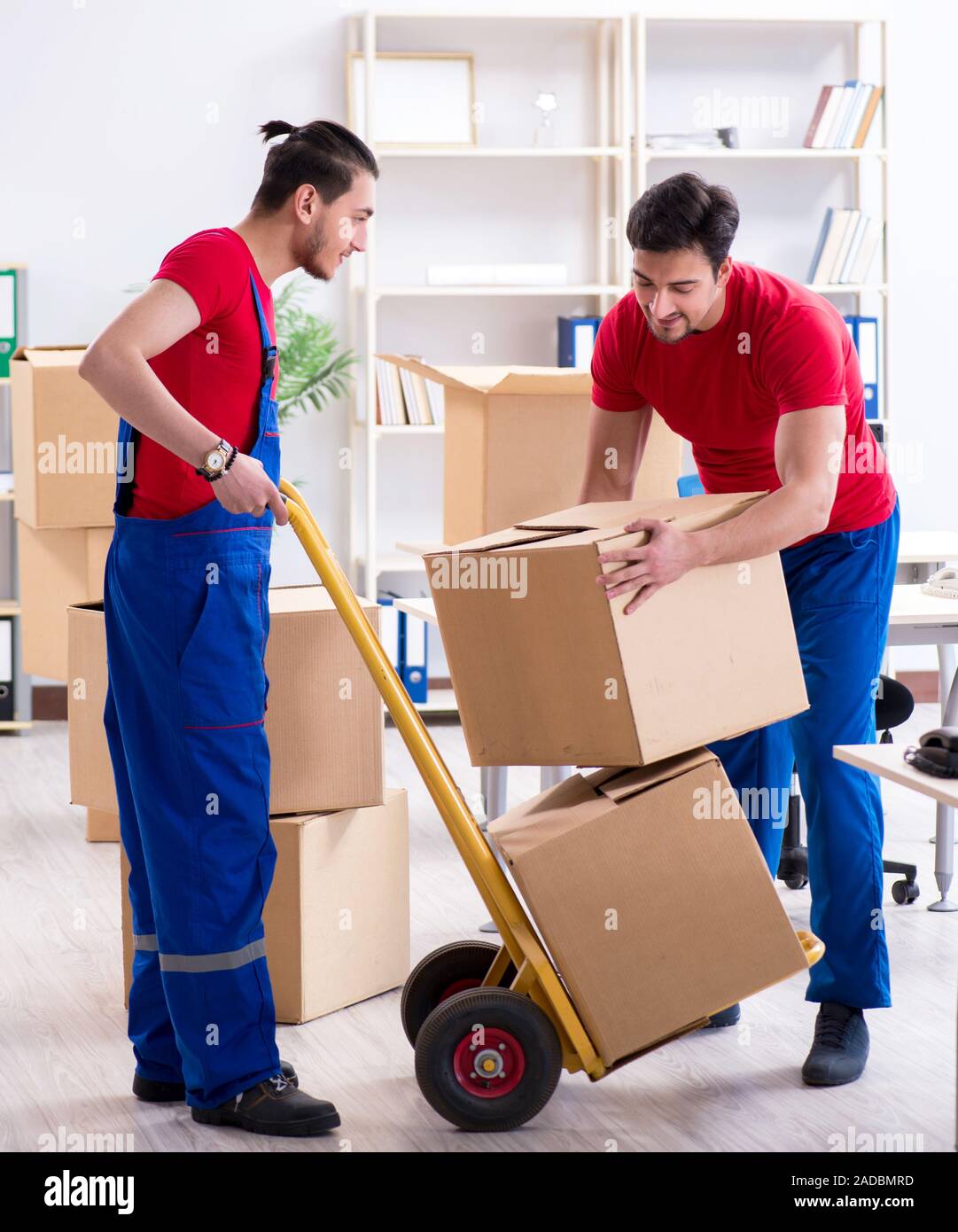 Two contractor employees moving personal belongings Stock Photo - Alamy