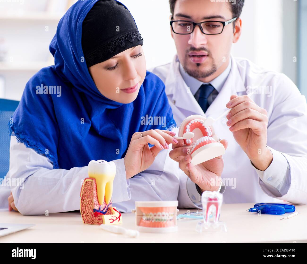Dentist doctor and assistant working on new tooth implant Stock Photo ...