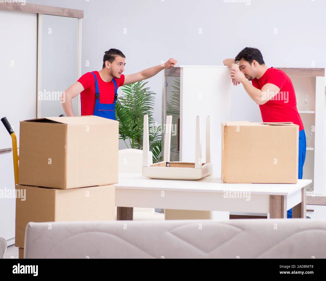 Two contractor employees moving personal belongings Stock Photo - Alamy