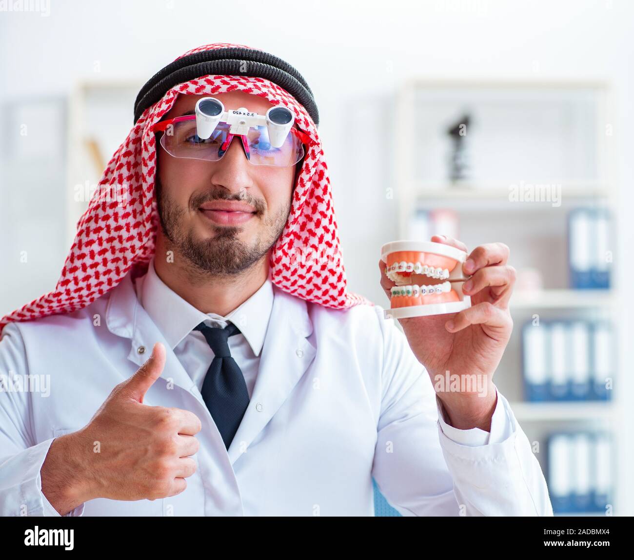 Arab dentist working on new teeth implant Stock Photo - Alamy