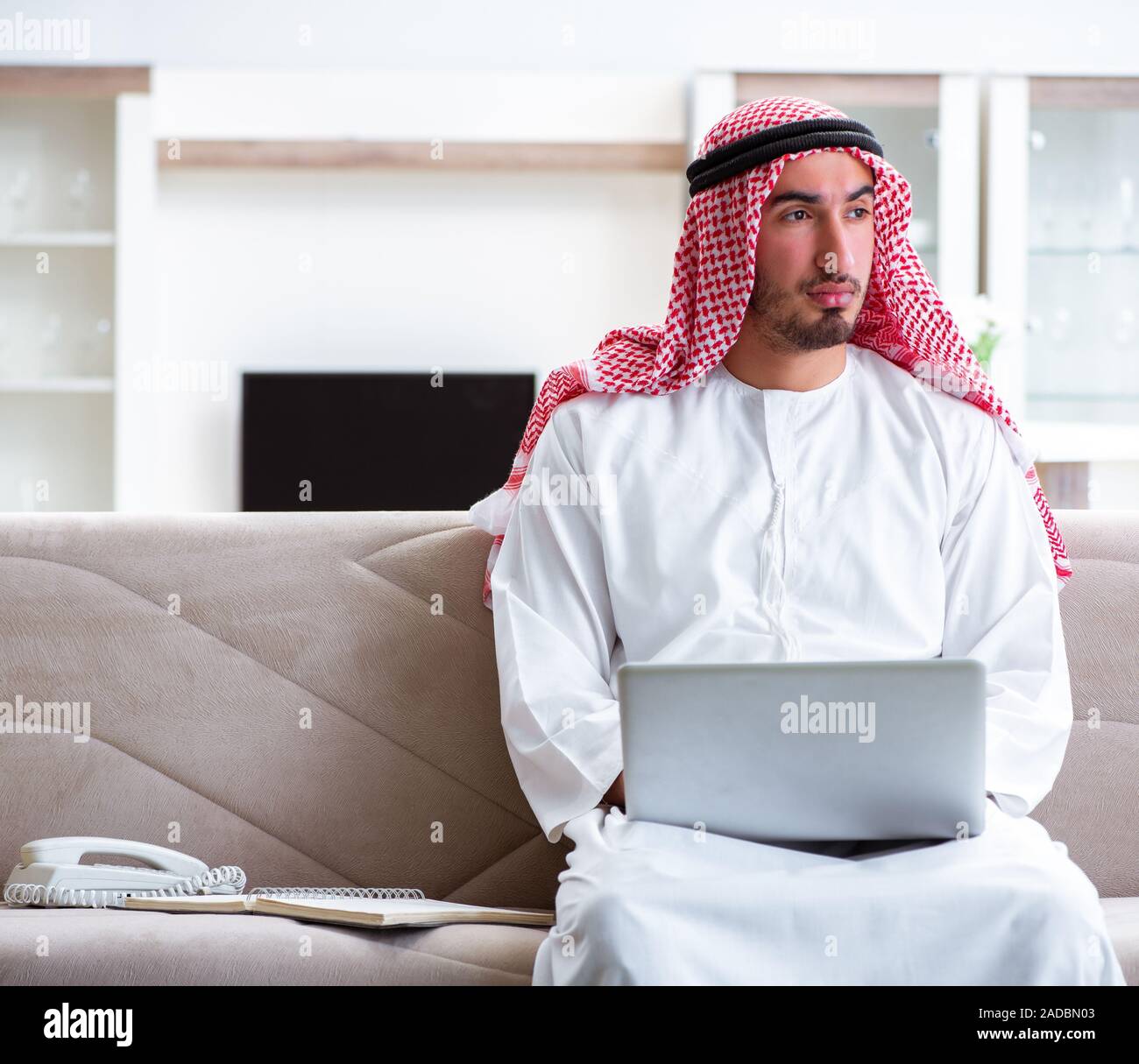 Arab man working at home on his work Stock Photo - Alamy