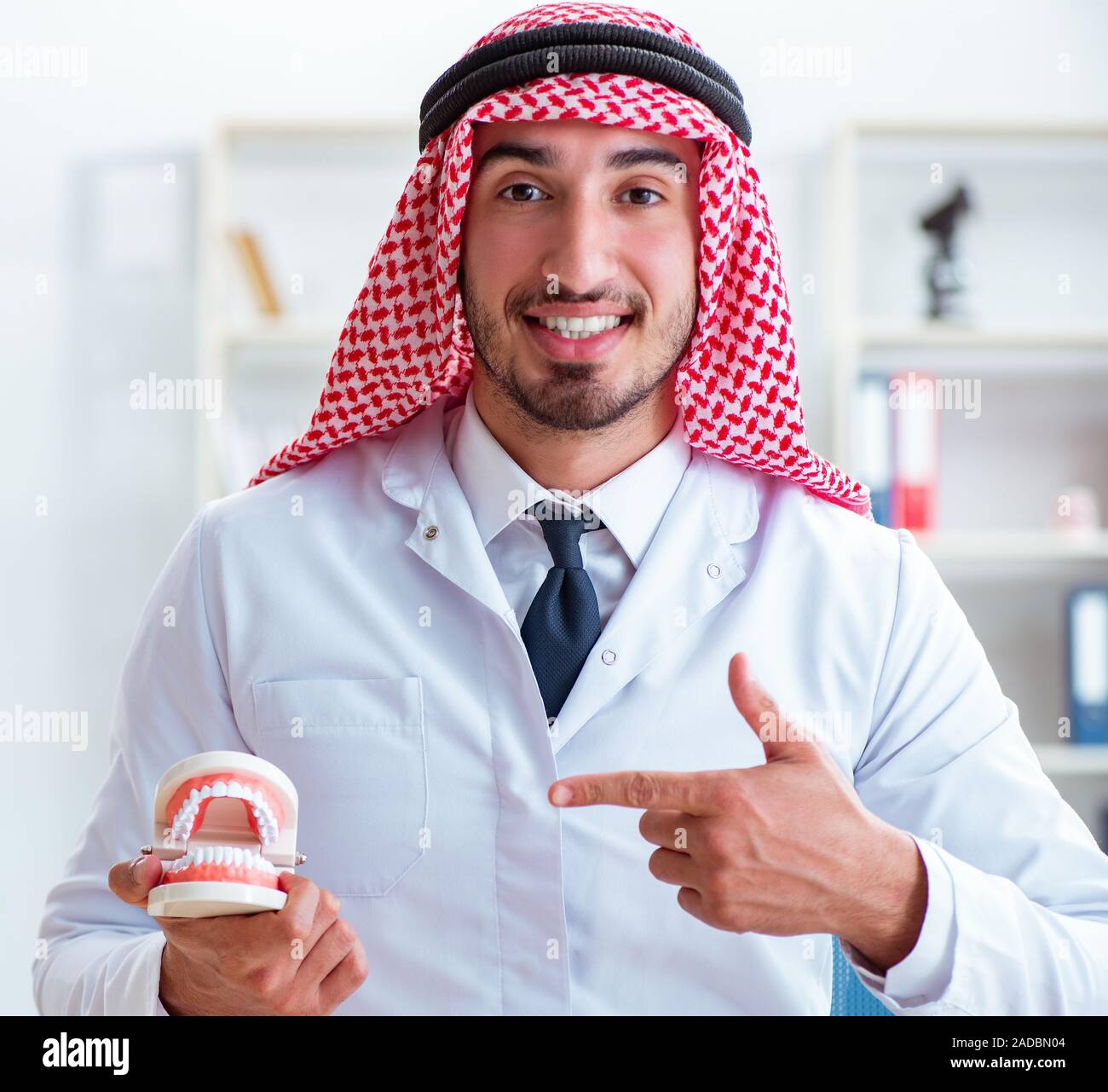 Arab dentist working on new teeth implant Stock Photo - Alamy