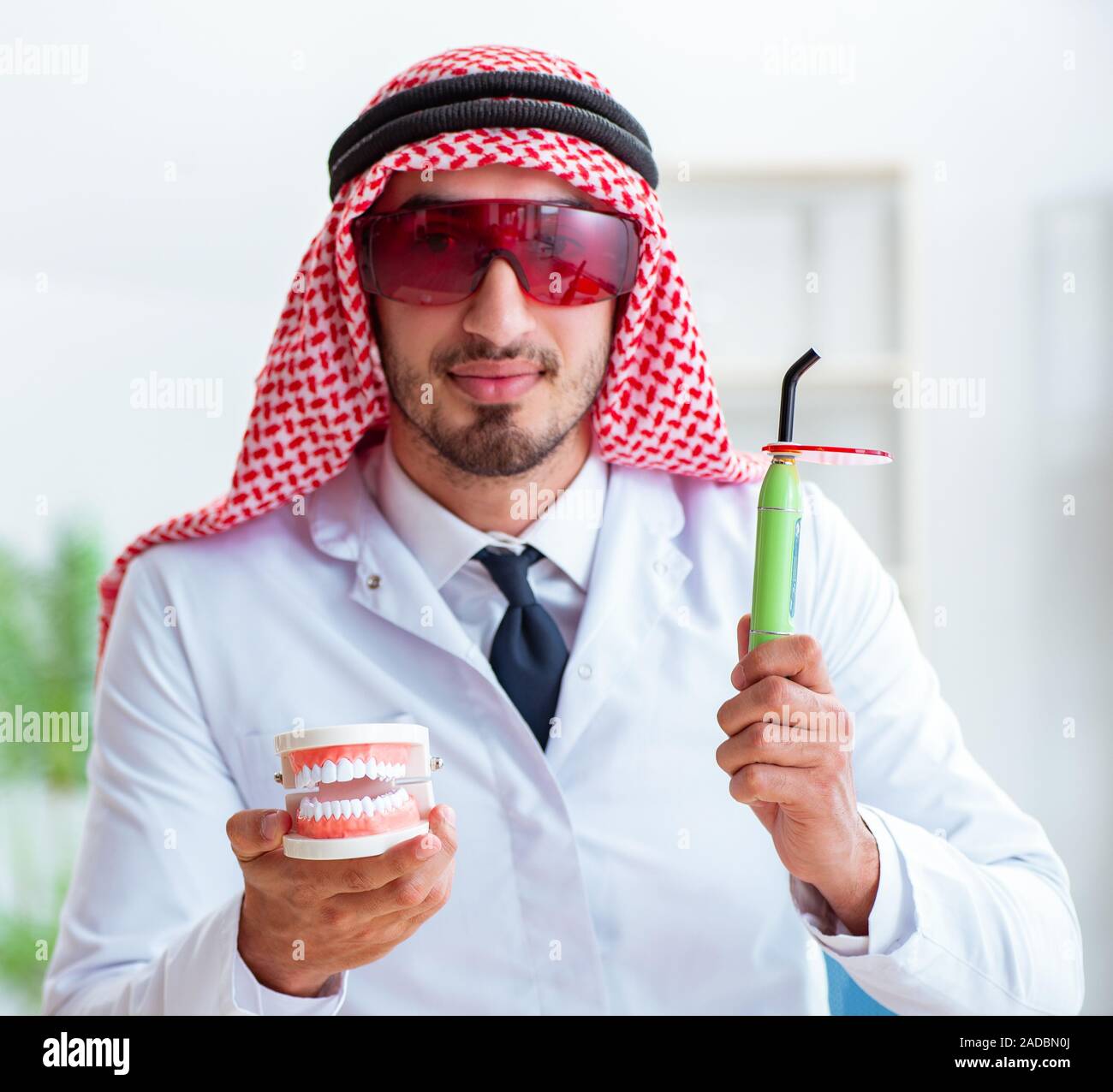 Arab dentist working on new teeth implant Stock Photo - Alamy