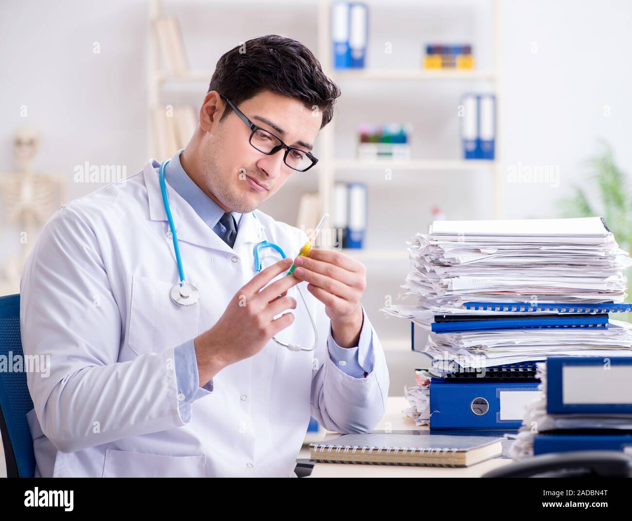 Busy doctor with too much work in hospital Stock Photo - Alamy