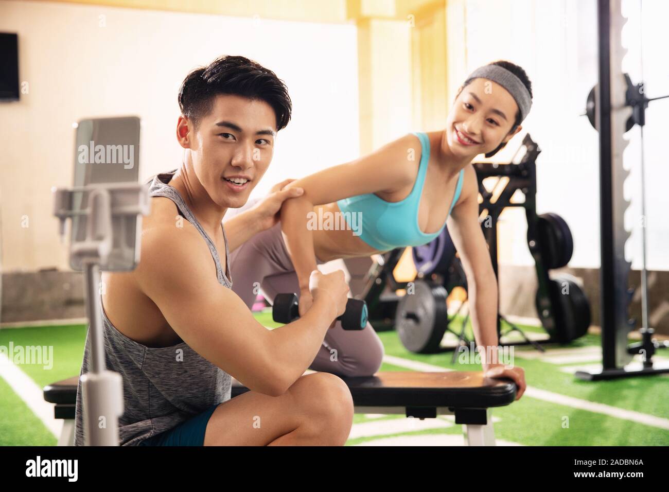 Young people live in the gym to work out Stock Photo - Alamy