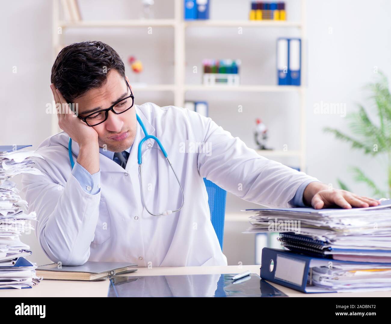 Busy doctor with too much work in hospital Stock Photo - Alamy