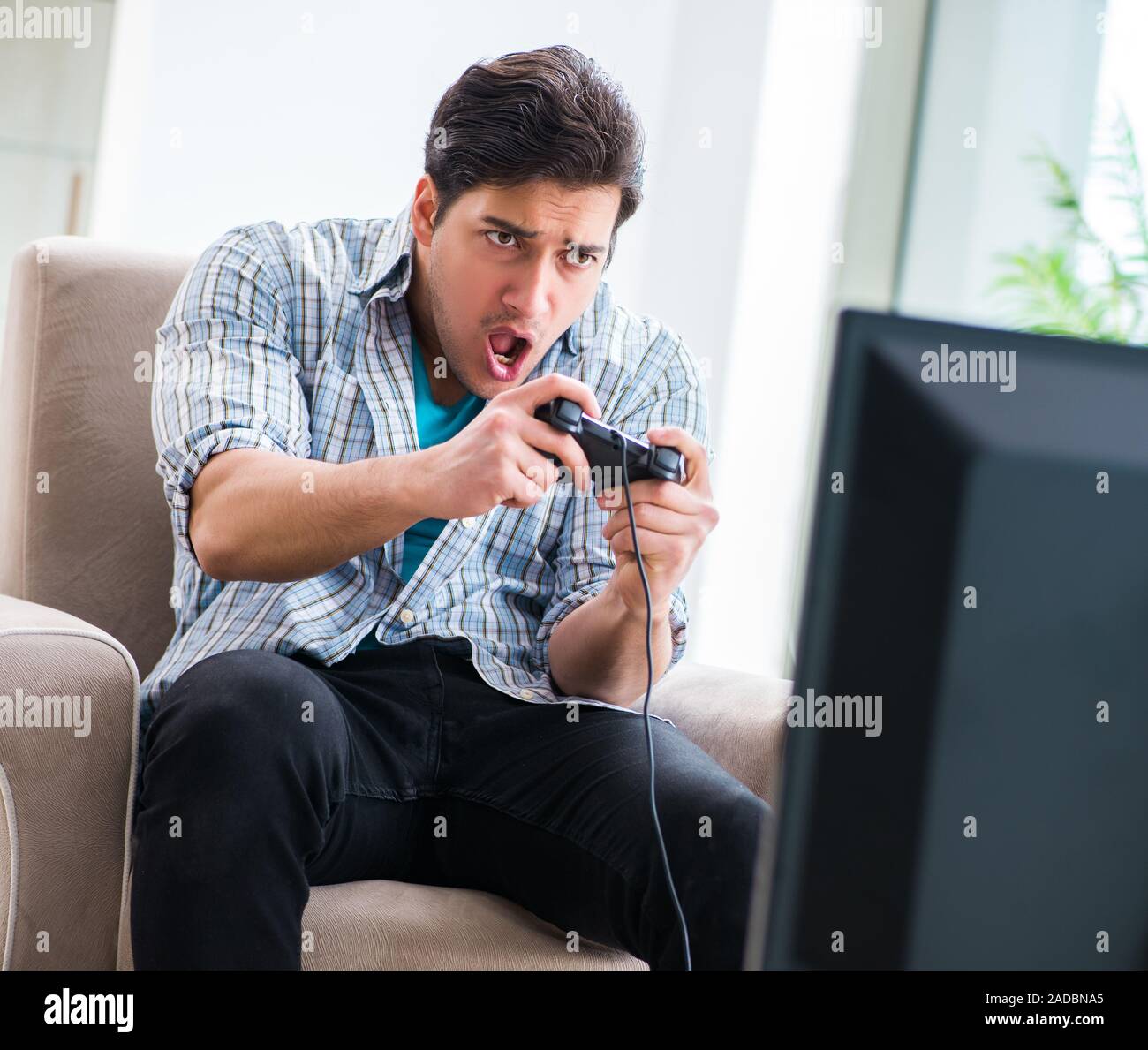 Man playing computer game at home Stock Photo - Alamy
