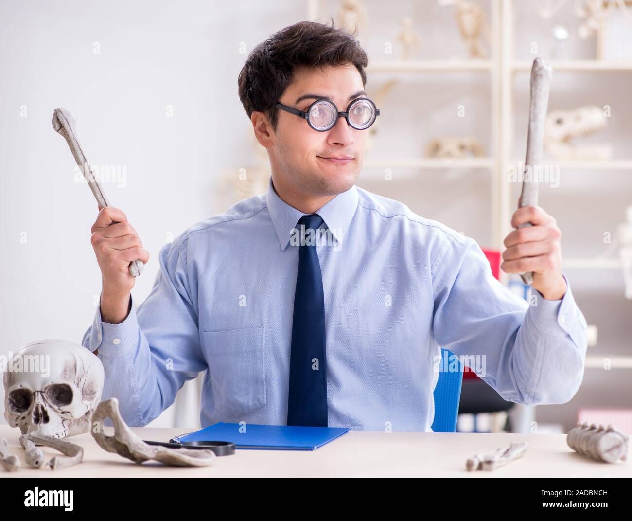 Funny crazy professor studying human skeleton Stock Photo - Alamy