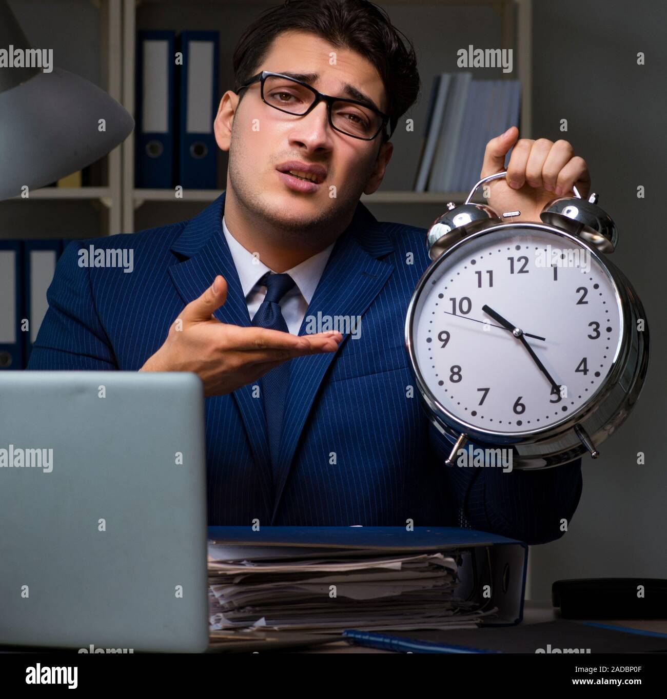 Employee staying late to finish work on auditing Stock Photo - Alamy