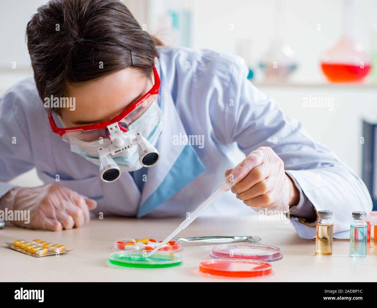 Lab assistant in drug synthesis concept Stock Photo - Alamy