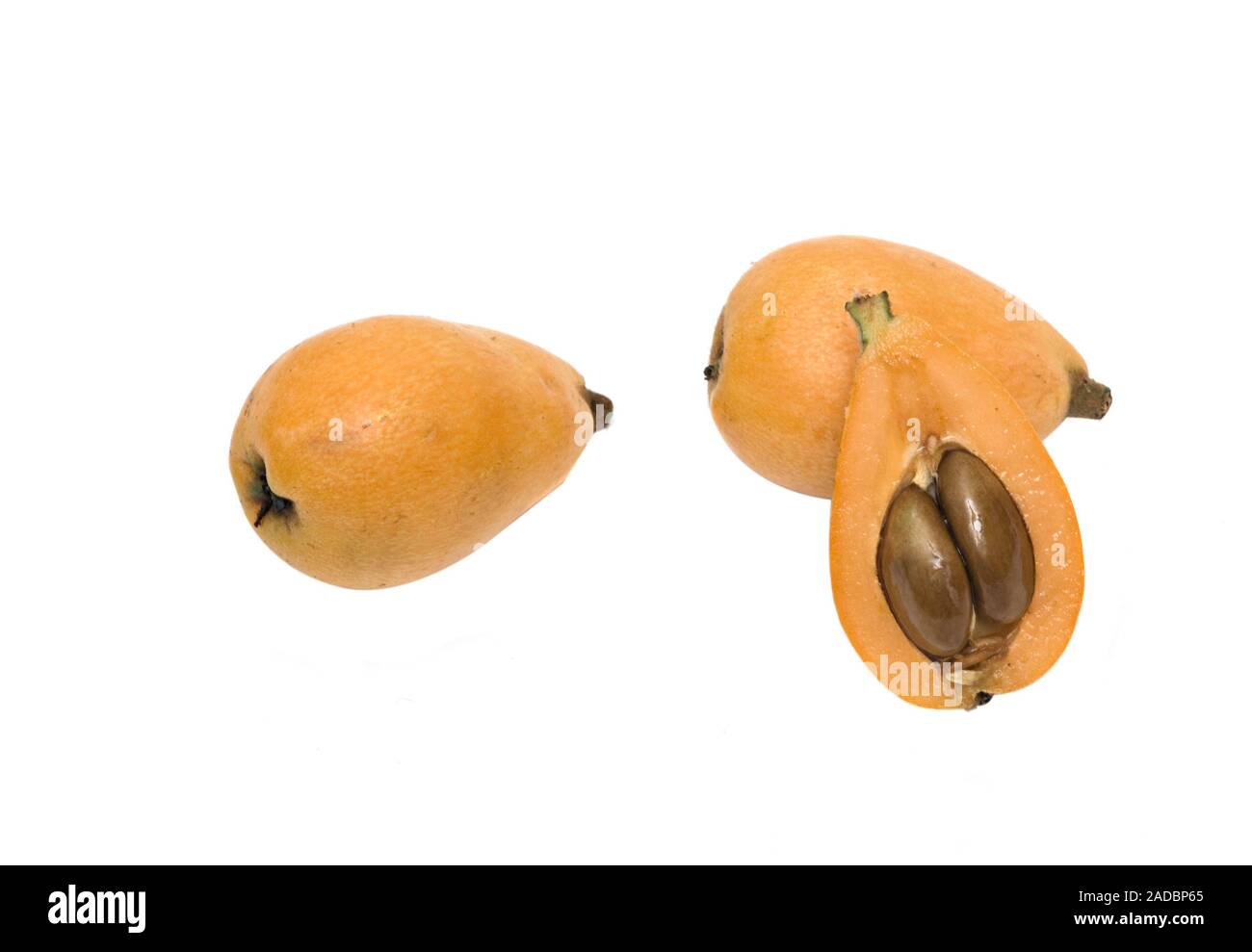 Loquat and its section isolated on white background Stock Photo - Alamy