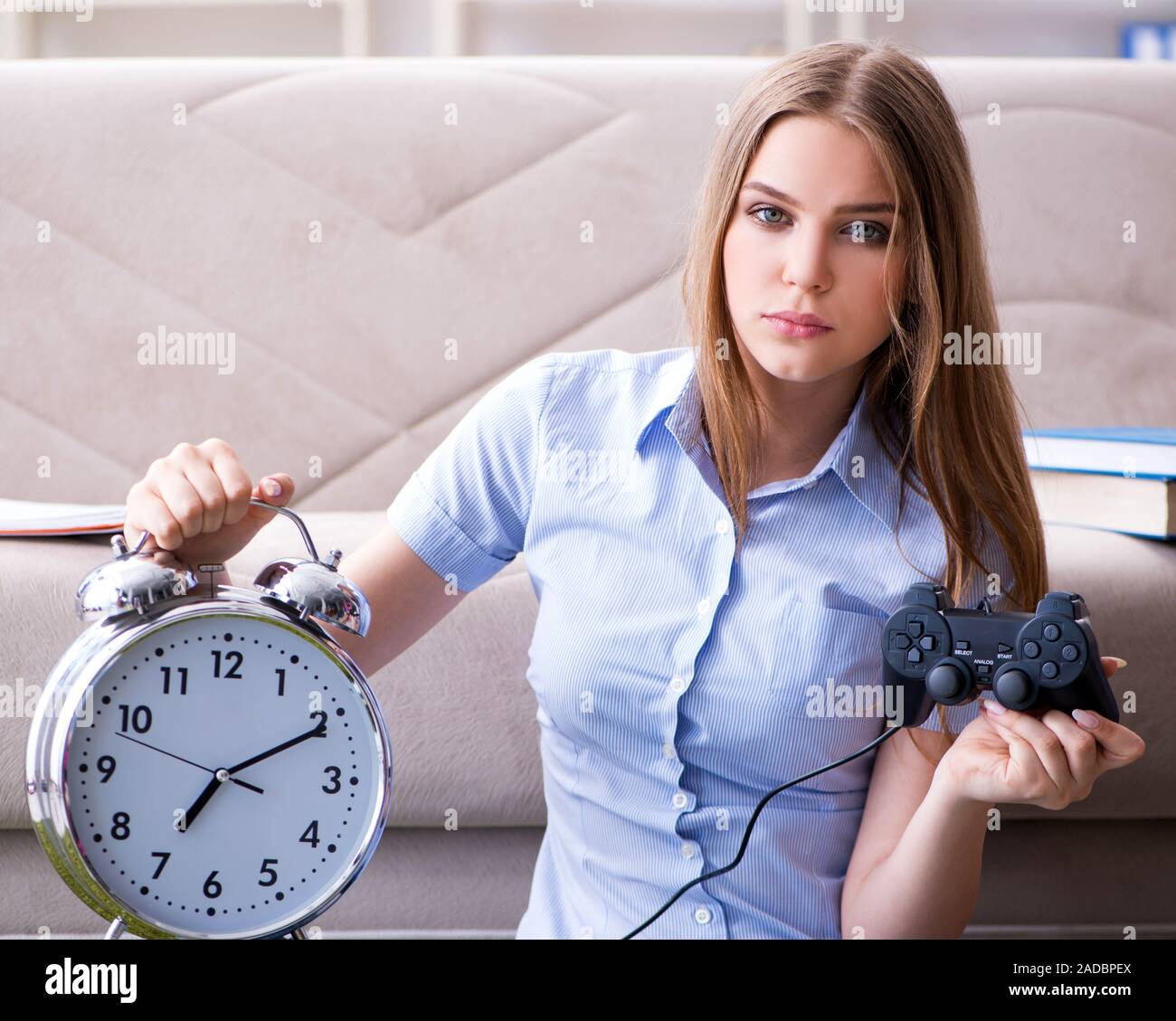 Female student being distracted from exam preparation Stock Photo - Alamy
