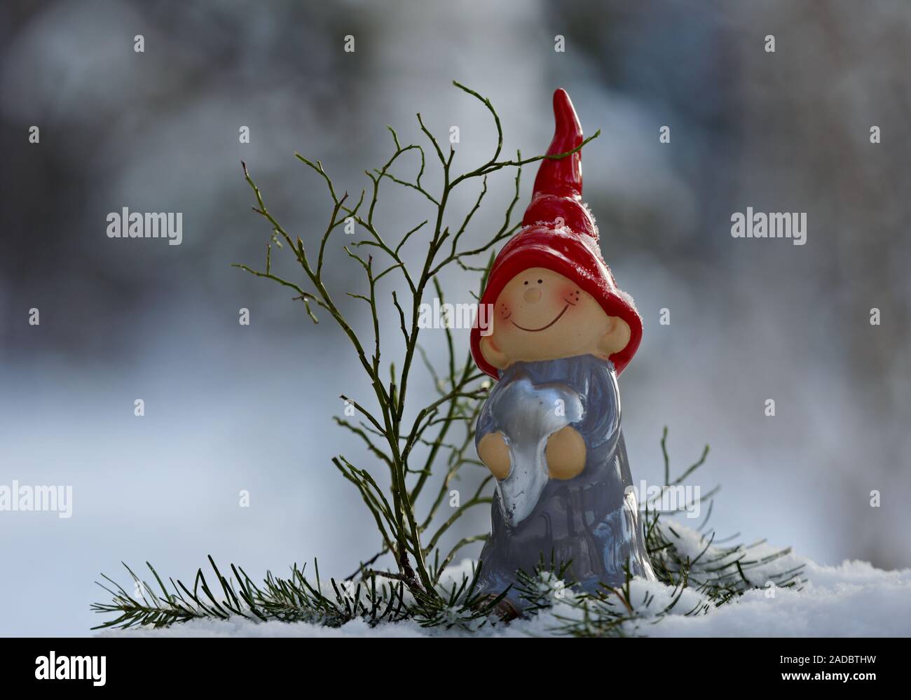 A christmas elf figure standing outdoors with blueberry and spruce ...