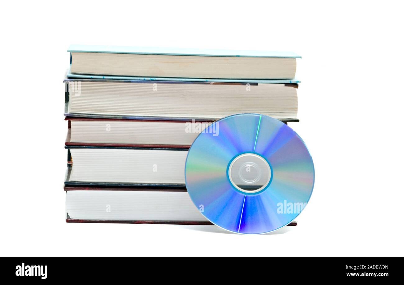 Pile of books and DVD disk as symbols of old and new methods of ...