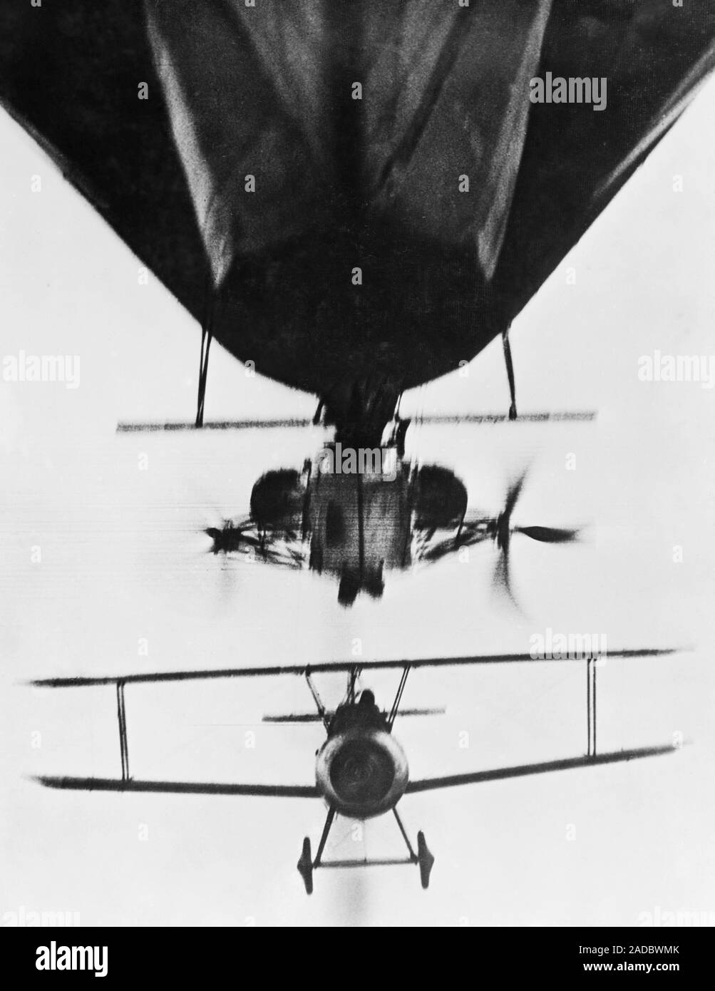 Biplane being released from airship. View of an early British aeroplane ...