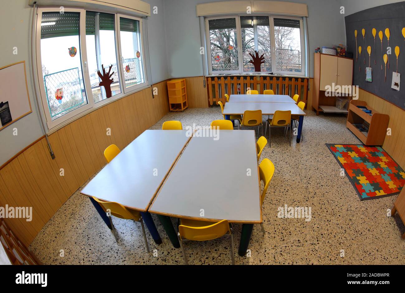 interior of a school class with low tables and small yellow chairs ...