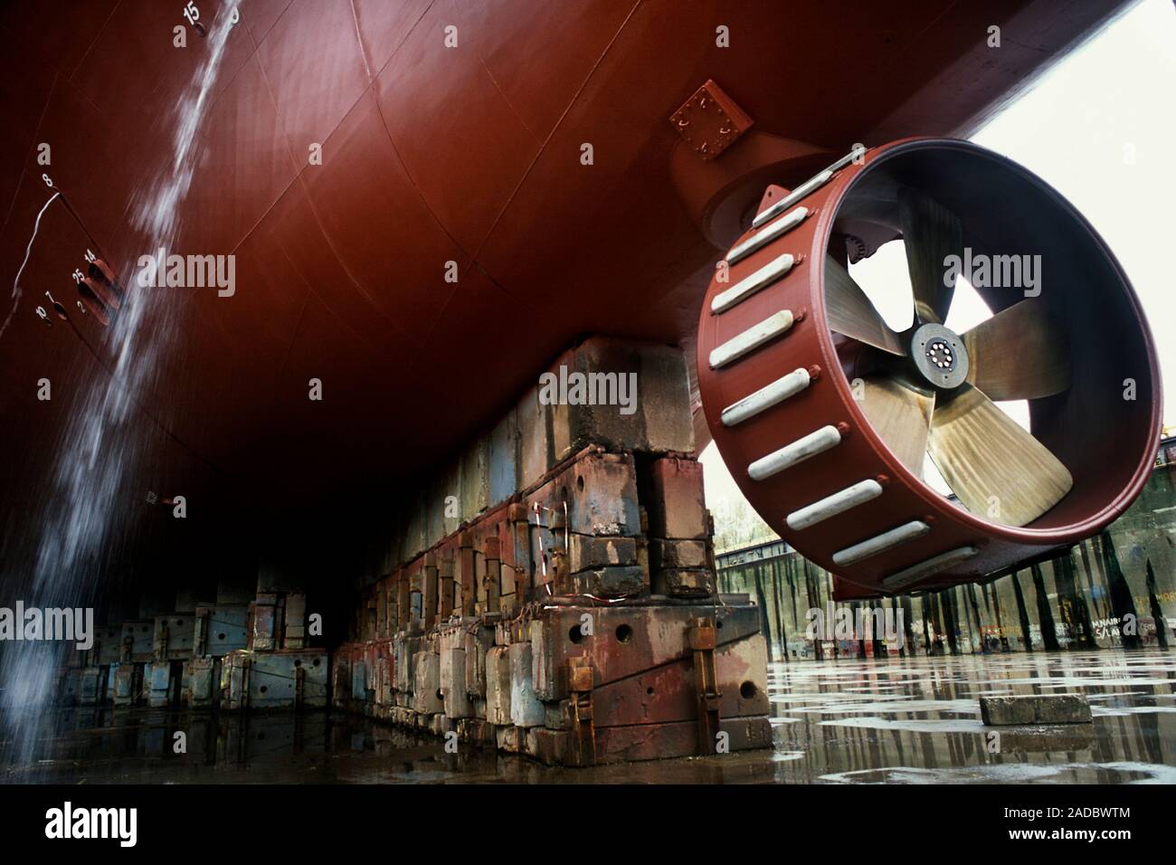 Propeller of a ship in a dry dock. The ship is undergoing maintenance ...