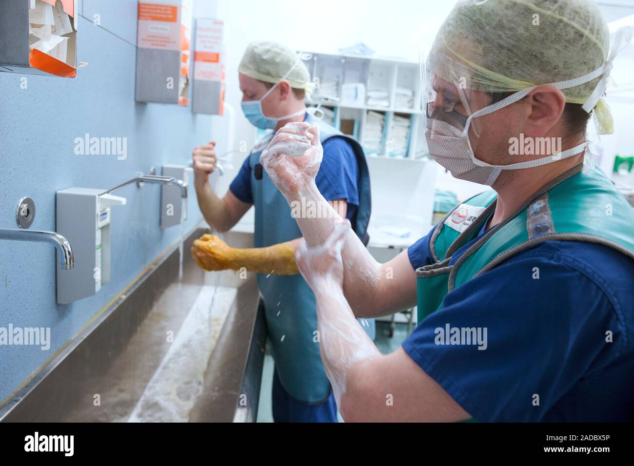 Surgeons 'scrubbing up'. Surgeons washing their hands and arms ...