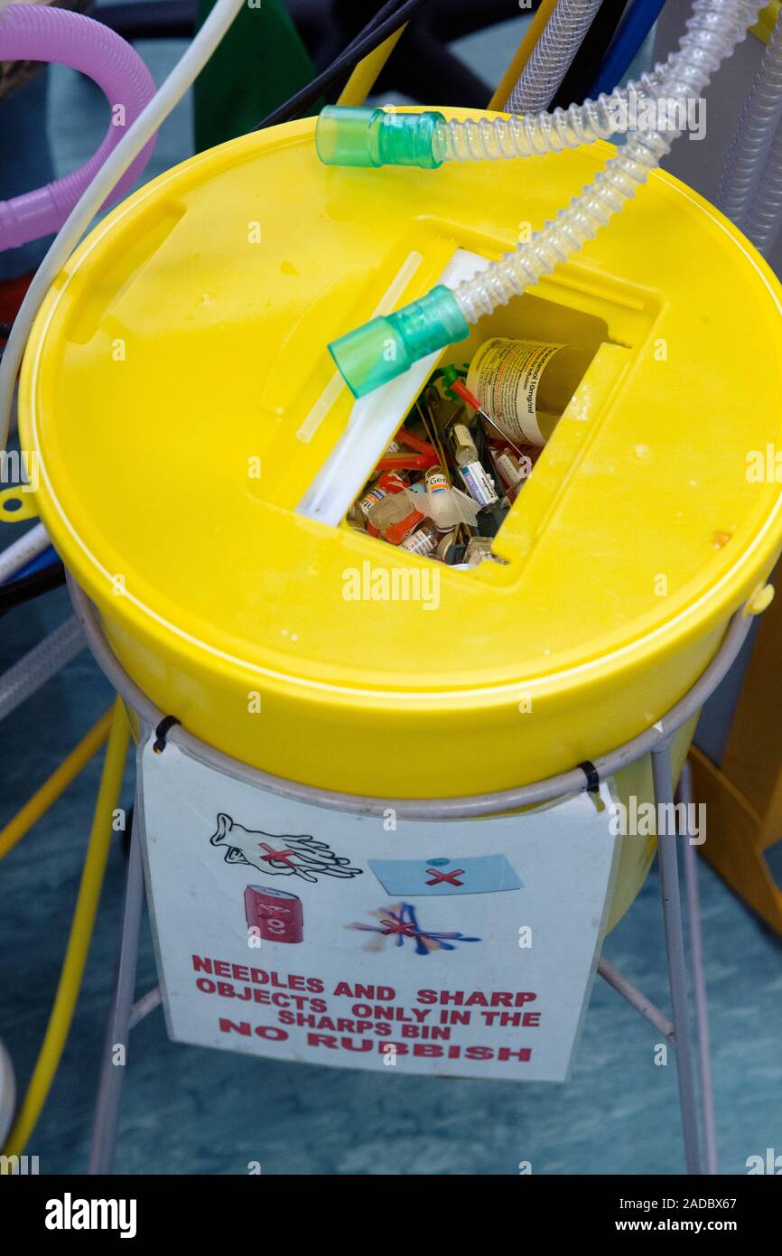 Sharps disposal bin. Close-up of a container used to dispose of needles ...