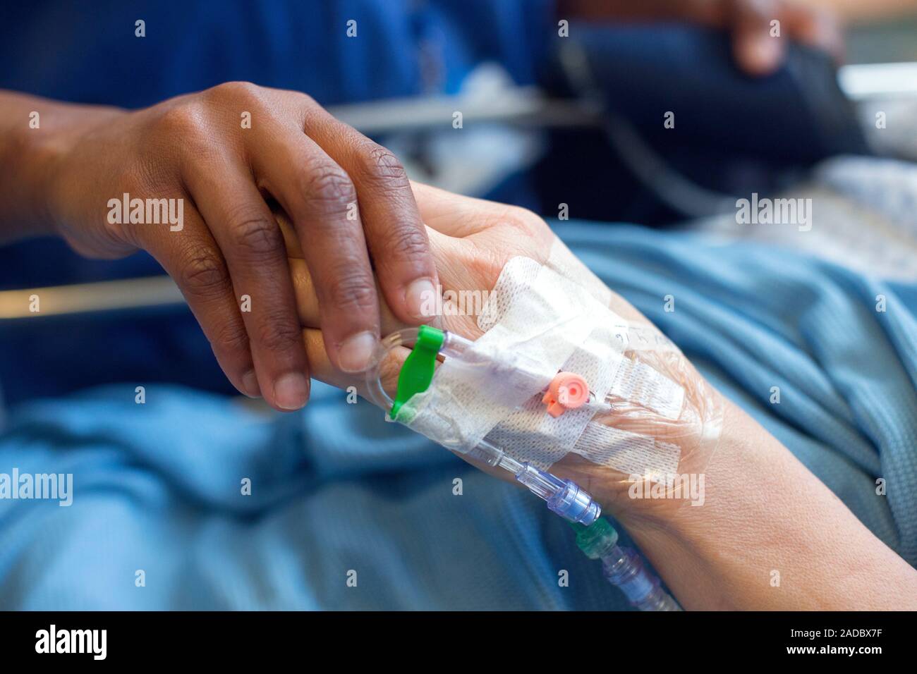 Nurse comforting hospital patient. Close-up of a nurse's hand ...