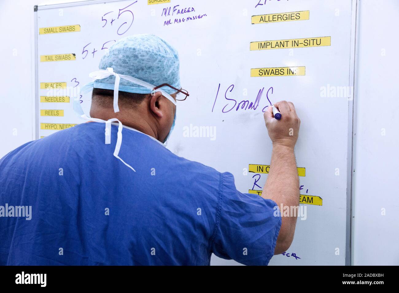 Surgical technician at work. Theatre technician recording what surgical ...