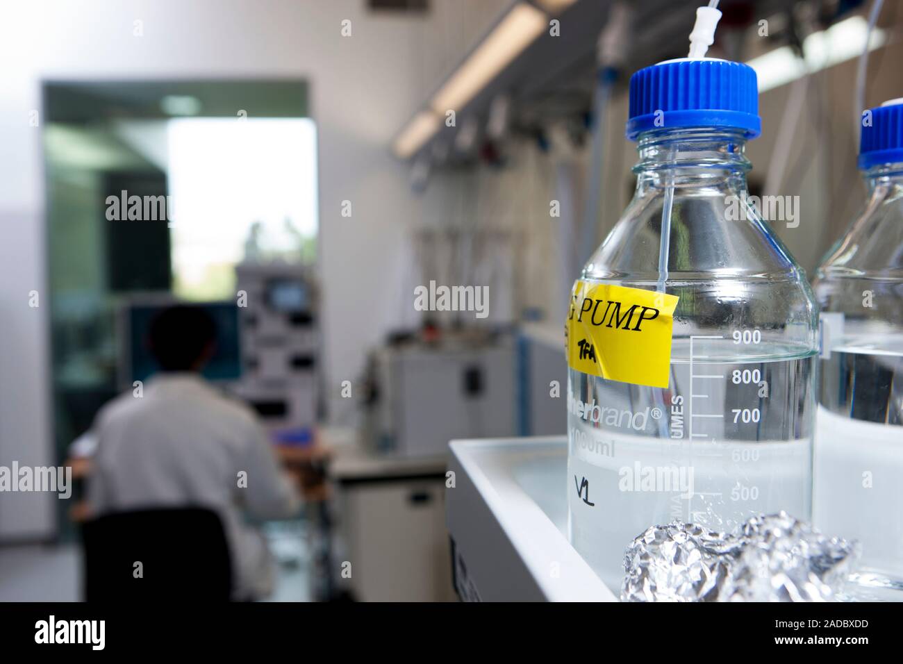 Mass spectrometer pump fluid. Close-up of a bottle containing pump ...