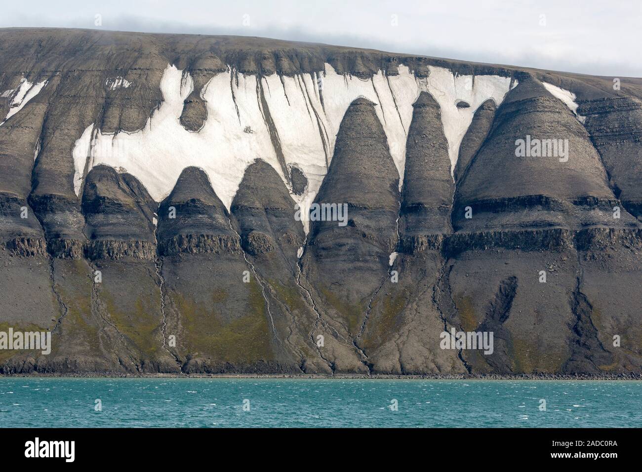 Horizontal strata of shale and intruded dolerite sill near Kap Lee ...