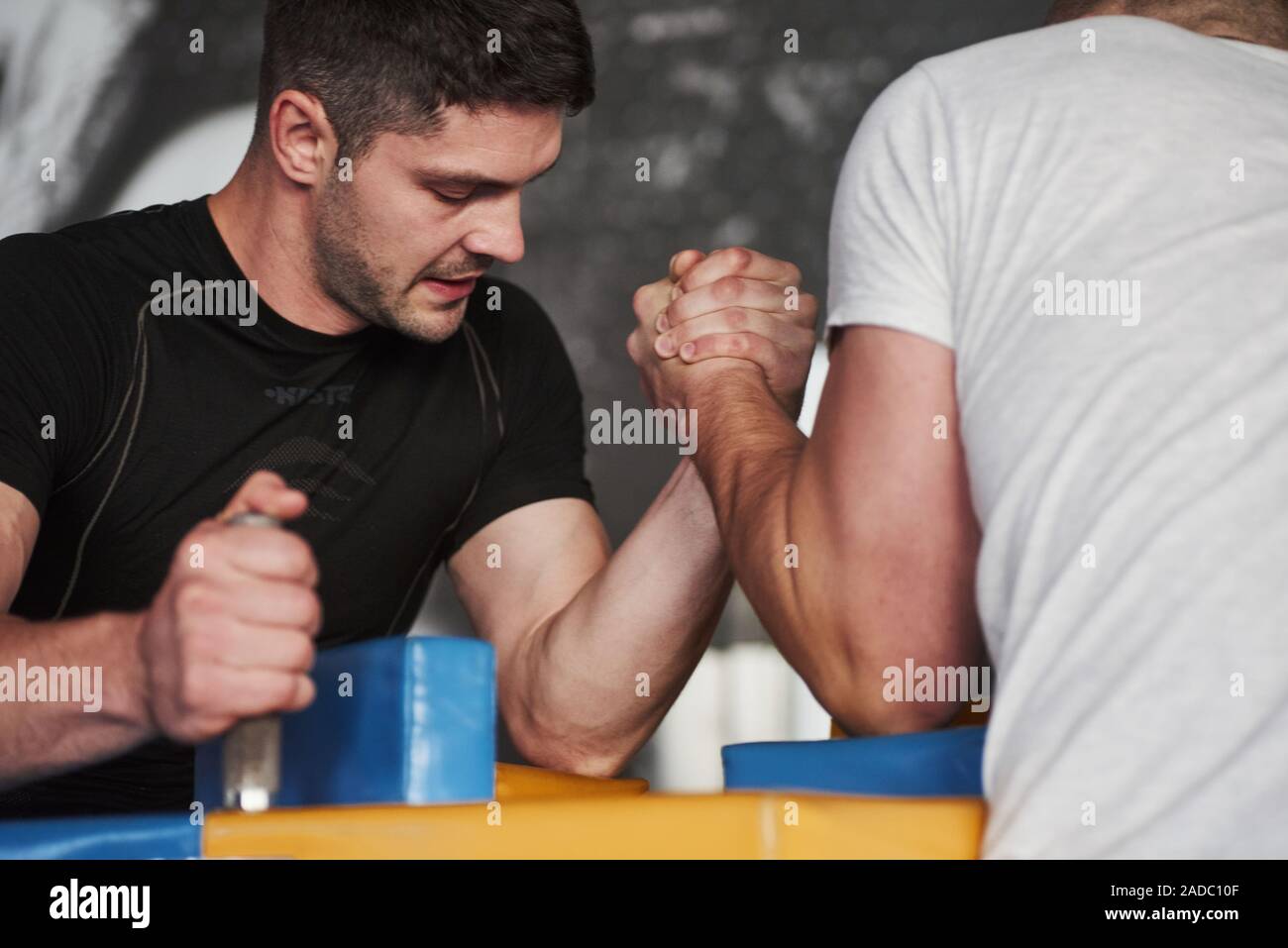 Struggling for win. Arm wrestling challenge between two men. Match on a ...